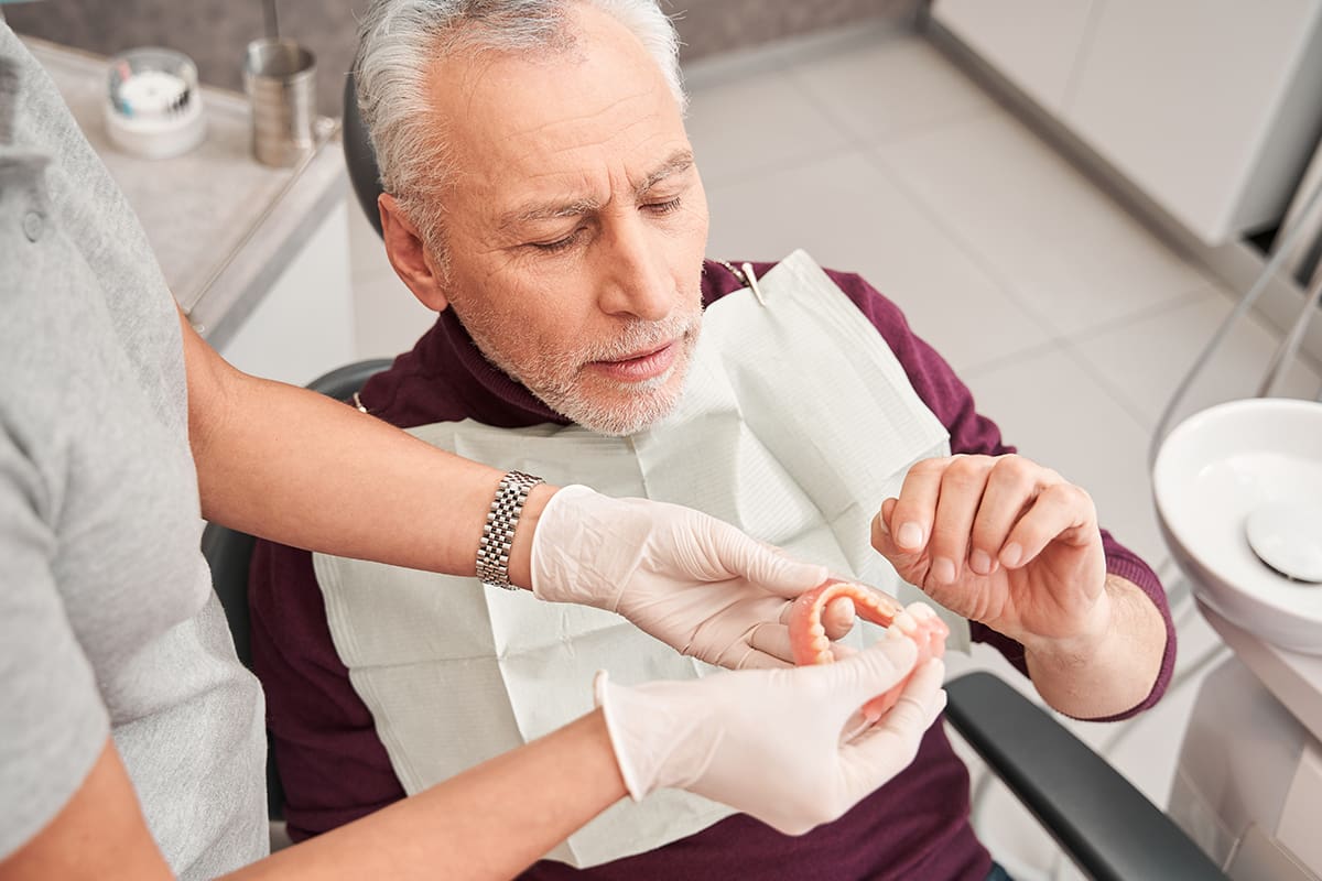 Hybrid Dentures vs. Traditional Dentures: Key Differences Explained